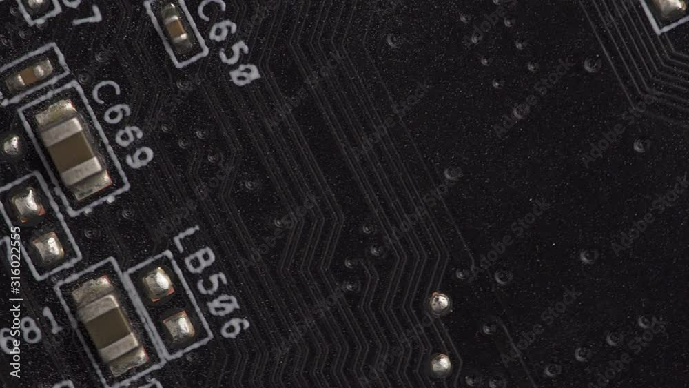 Rotating close up macro footage of printed circuit board PCB in 4K ...