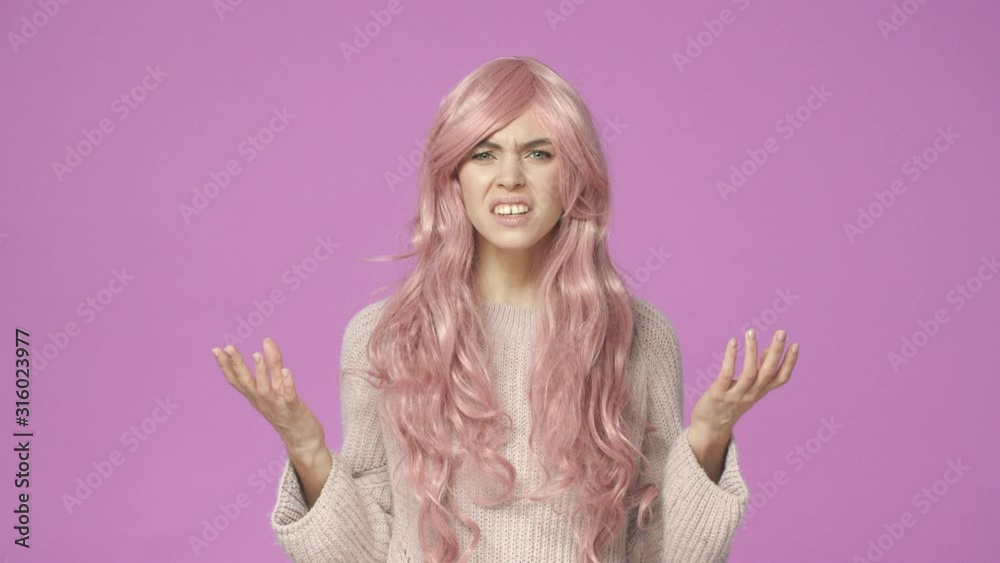 Slow-motion questioned and confused, bothered young woman in pink wig ...
