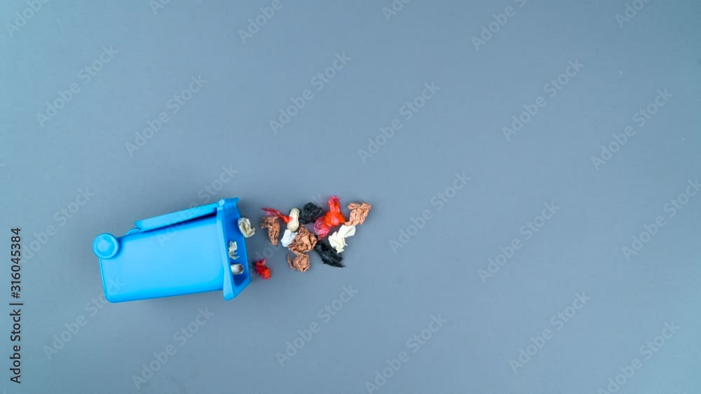 Stop motion animation of waste in and out from a trash can on blue ...