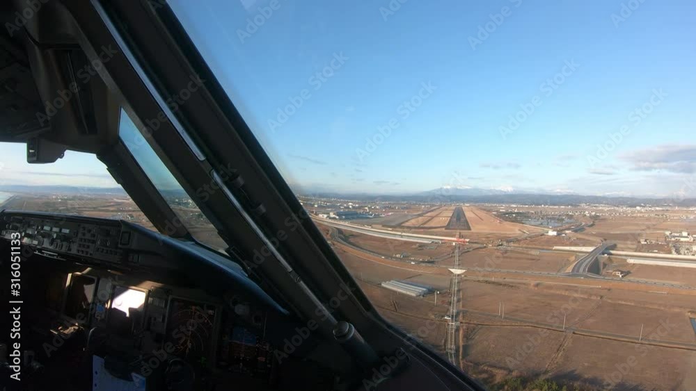 Inside cockpit view, commercial airplane flying toward runway ahead and ...