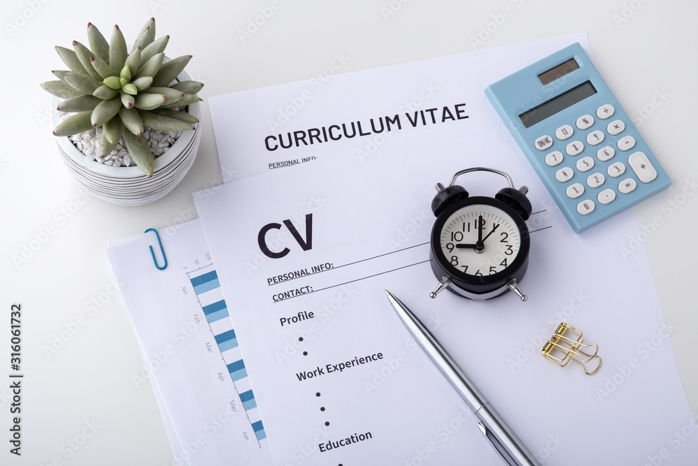 CV with pen and clock on white desk Stock Photo | Adobe Stock
