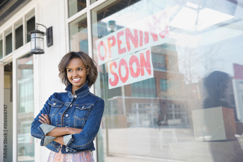 Business owner standing at new storefront Stock Photo | Adobe Stock