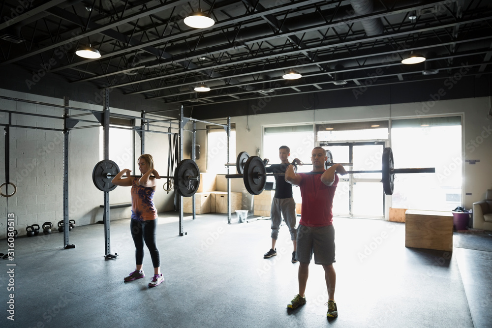 Exercise class weightlifting with barbells at gym Stock Photo | Adobe Stock