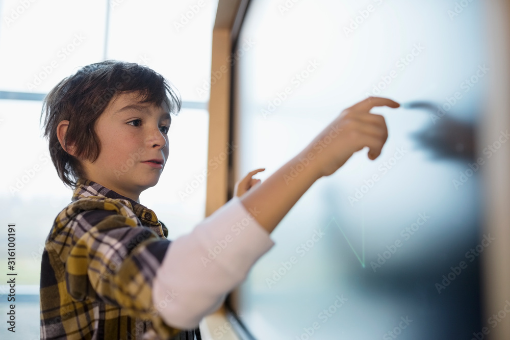 Boy using touch screen in science center Stock Photo | Adobe Stock