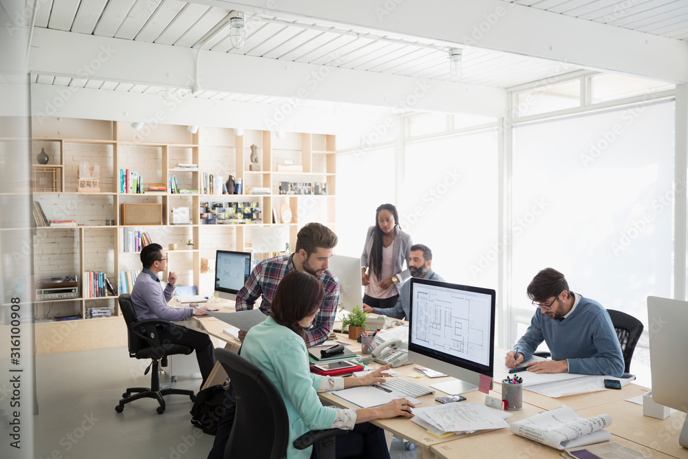 Architects working at computers in open plan office Stock Photo | Adobe ...