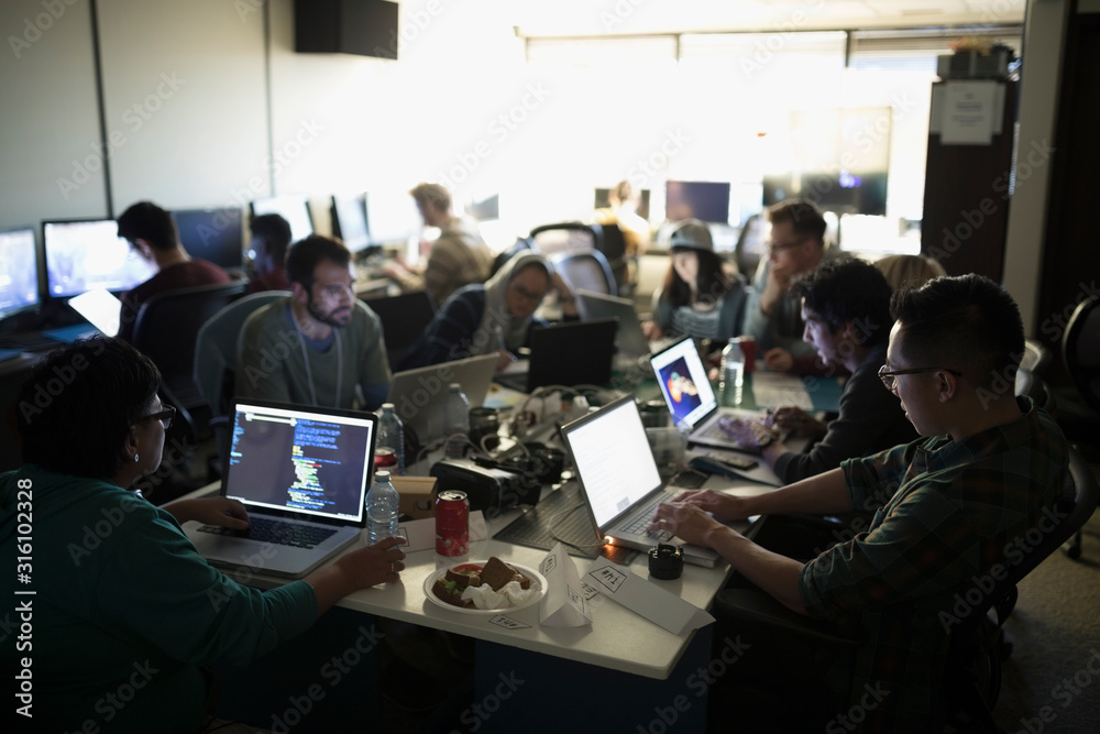 Hackers working hackathon at laptops in dark office Stock Photo | Adobe ...