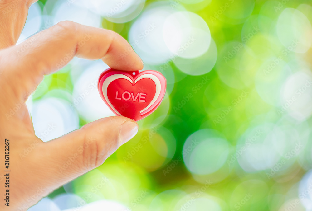 hand holding love heart on nature bokeh background Stock Photo | Adobe ...
