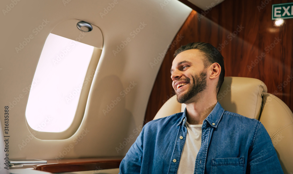 Happy flight. Close-up photo of a happy man in a casual outfit, who is ...