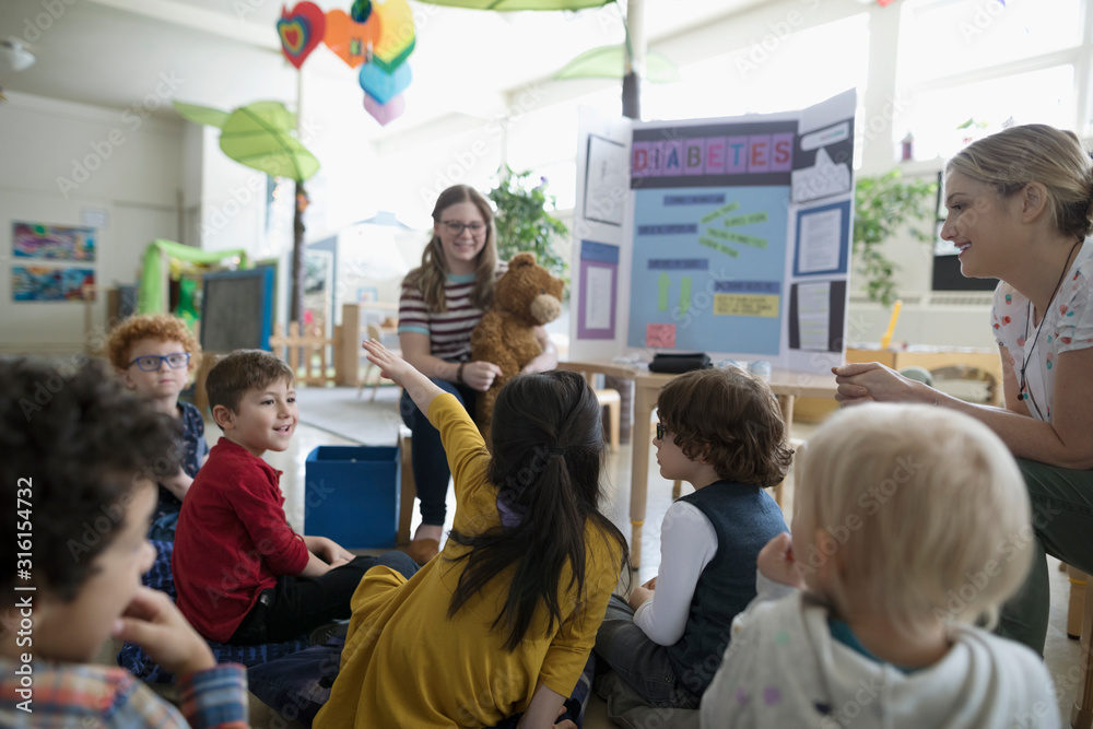 Preschool students watching tween girl giving diabetes presentation in ...