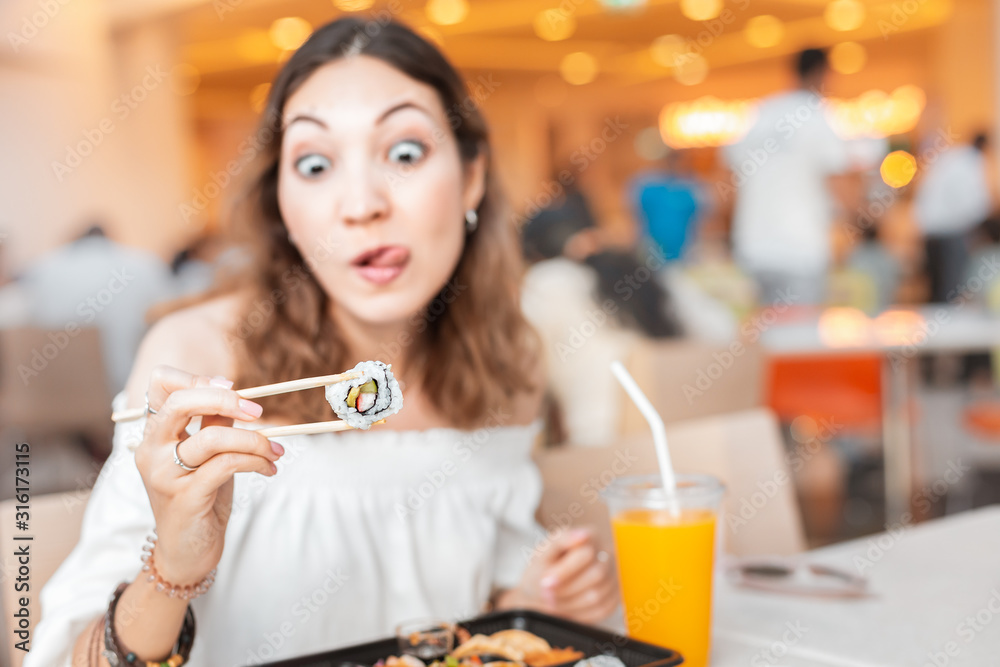 Funny Girl eating sushi with chopsticks while having Bento lunch in the ...