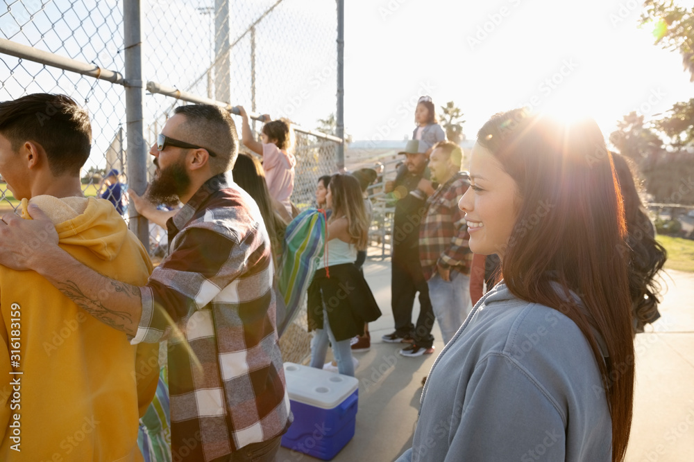 Smiling baseball fans watching game Stock Photo | Adobe Stock