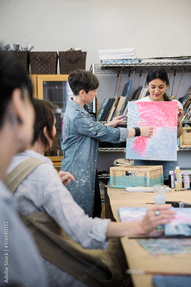 Teacher and student presenting painting in art class Stock Photo ...