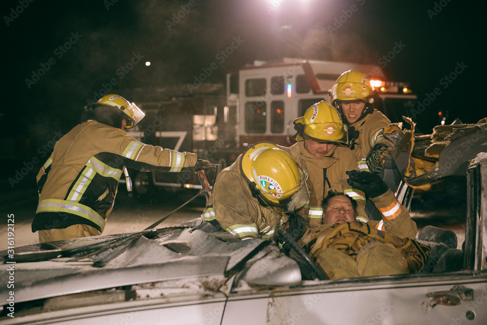 Firefighters training, rescuing victim at scene of car accident Stock ...