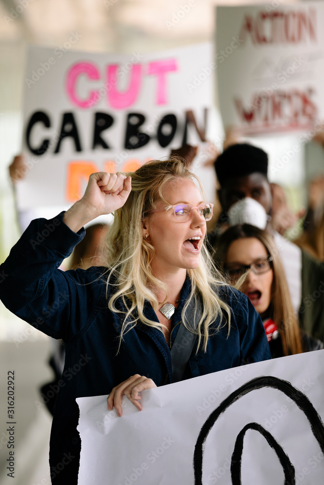 Student holding poster and chanting against climate change Stock Photo ...