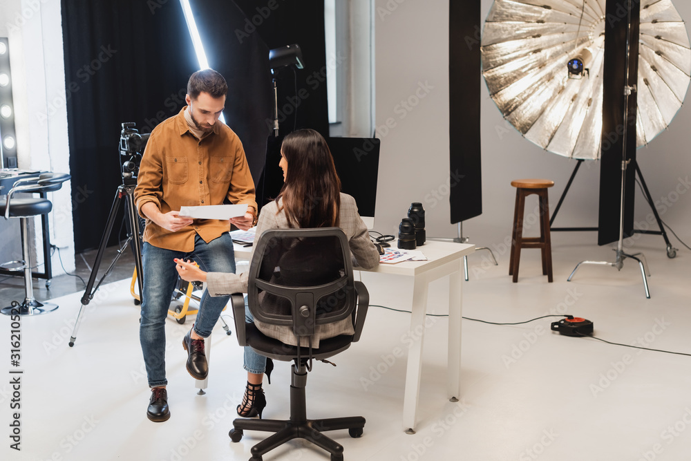 back view of producer and photographer talking on backstage Stock Photo ...