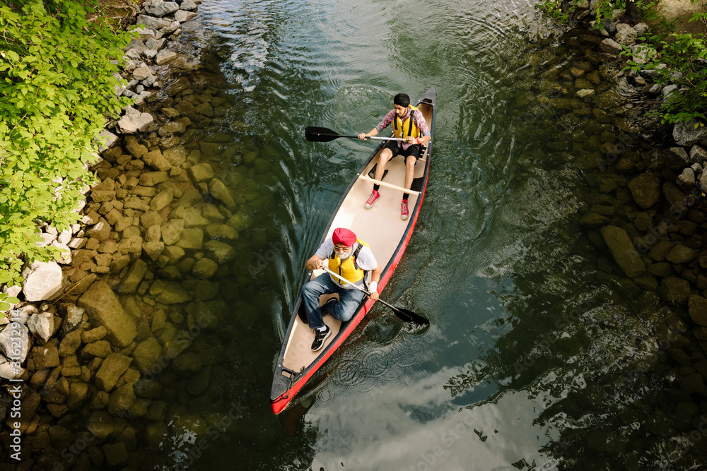 Overhead view of two men canoeing on river Stock Photo | Adobe Stock