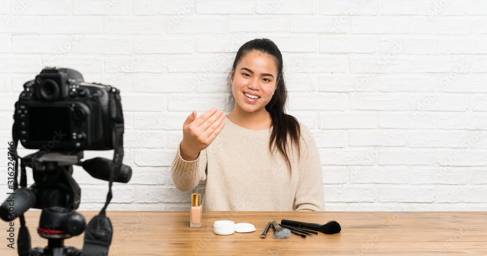 Young blogger Asian girl recording a video tutorial inviting to come ...