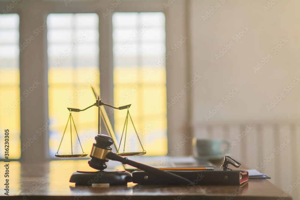 The mallet and brass scales are placed on the table in the lawyer's ...