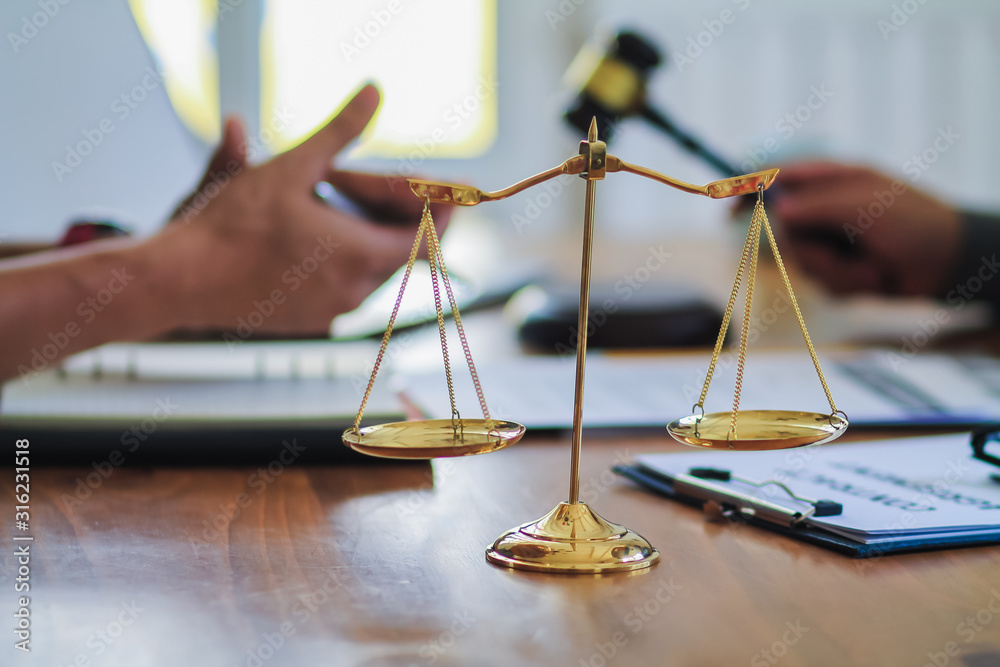Brass scales are placed on the tables within the lawyer's office for ...