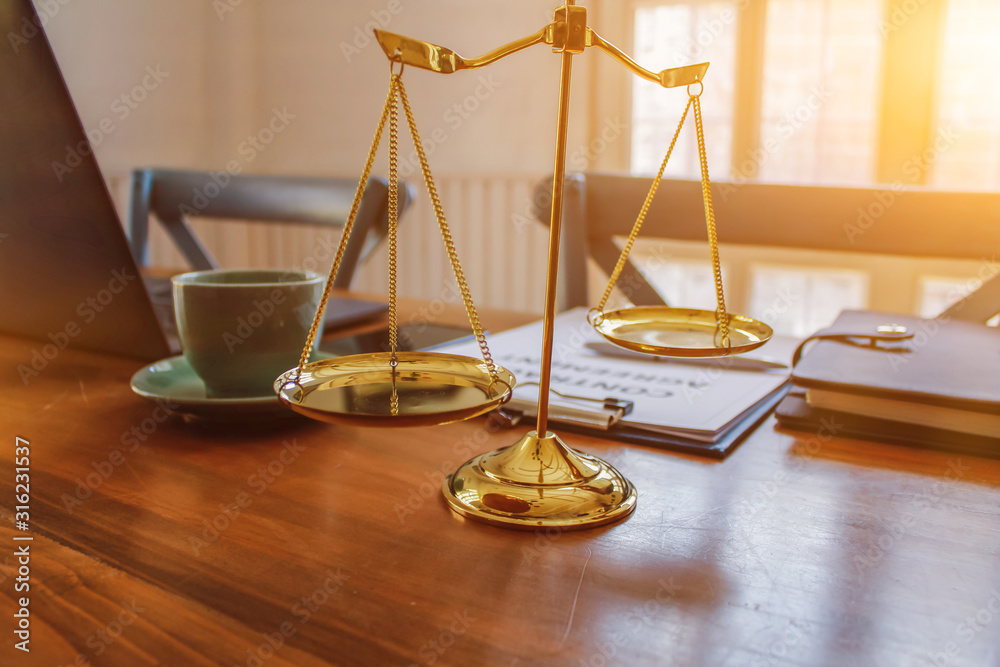 Brass scales are placed on the tables within the lawyer's office for ...