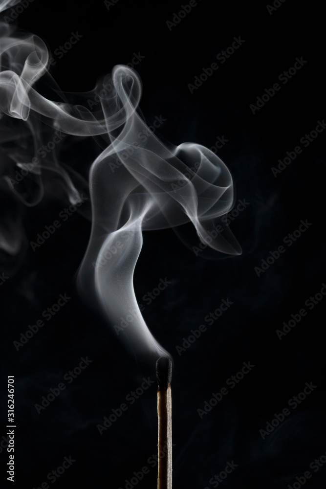 Extinguished matchstick smoke on black background Stock Photo | Adobe Stock