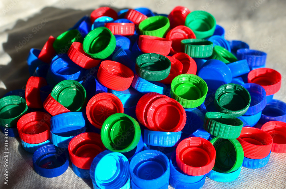 Plastic bottle caps background. Cap material is recyclable.Remove lids ...