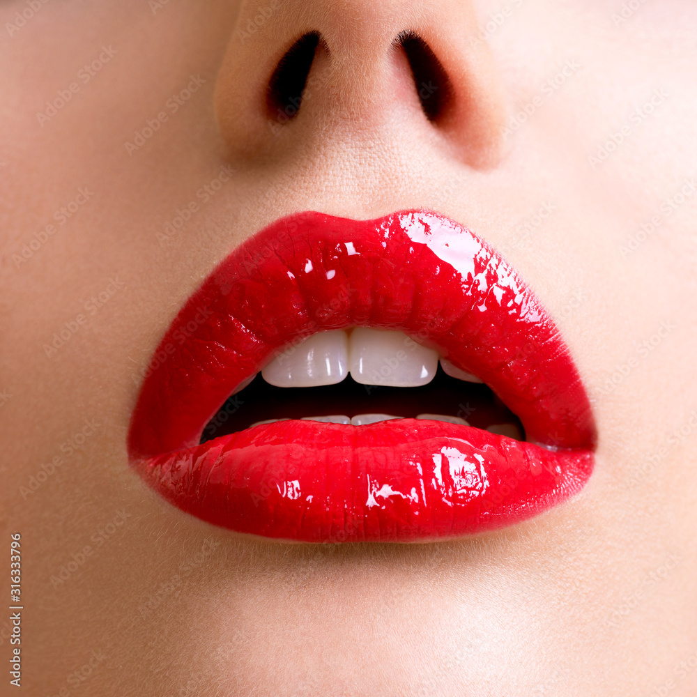 Closeup beautiful female lips with red lipstick. Stock Photo | Adobe Stock