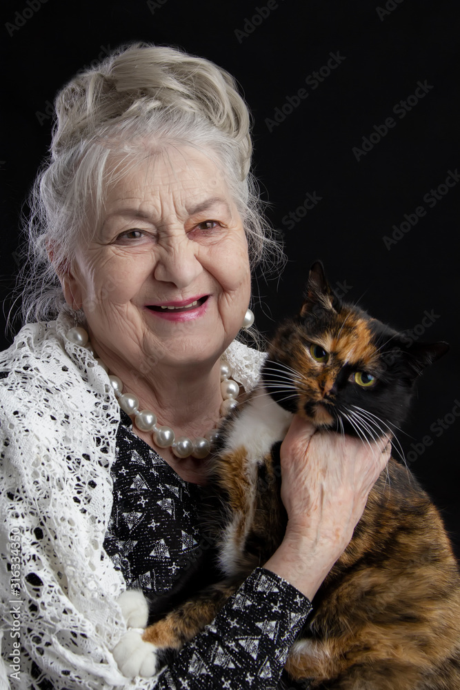 Portrait of a ninety year old woman with a pet. Merry old lady with a ...