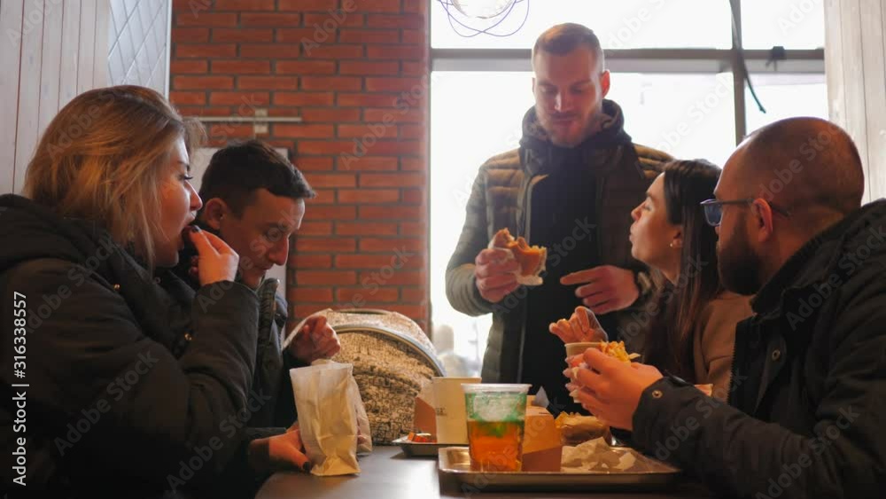 Hang out guys friends eat in fast food restaurant hamburgers french ...