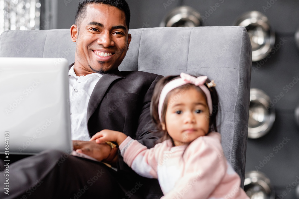 Little cute daughter distracts father from serious work. Parenting and ...