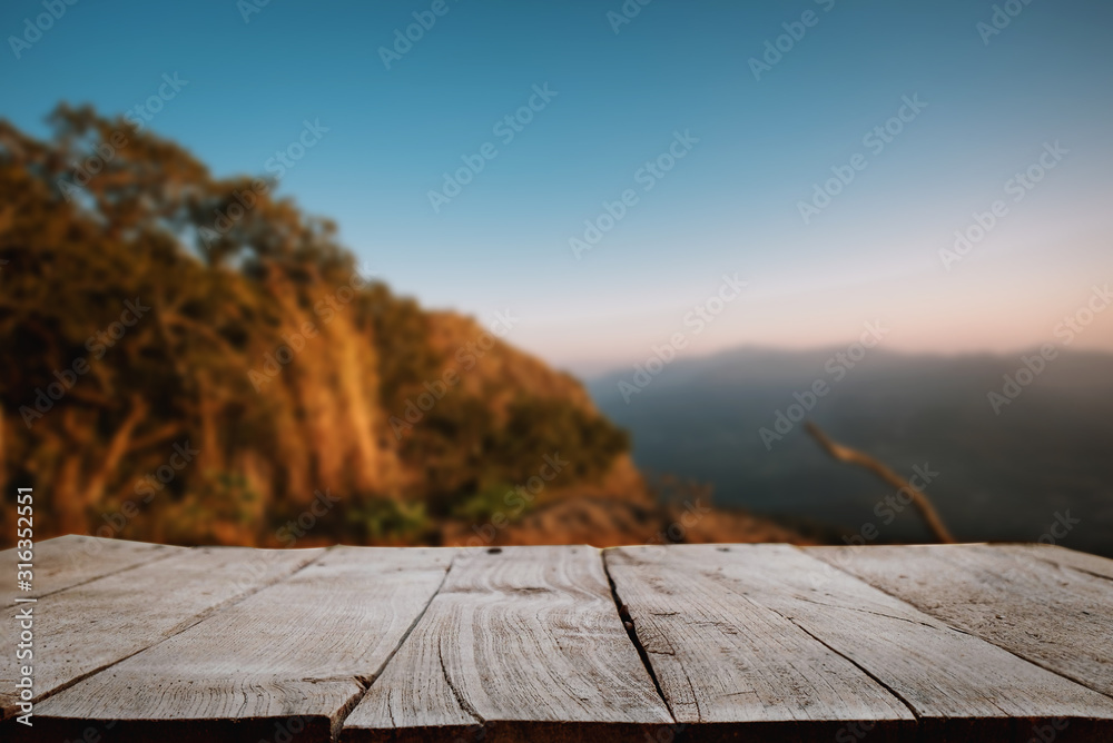 Wood table top in front of of trees in the forest. blur background ...