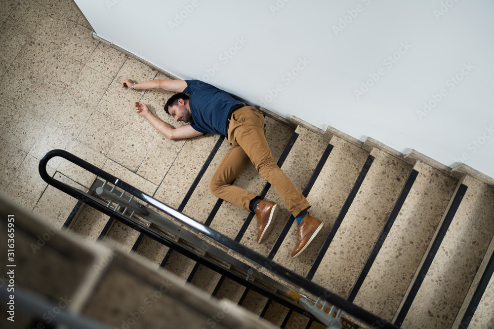 Unconscious Man Lying On Staircase Stock Photo | Adobe Stock