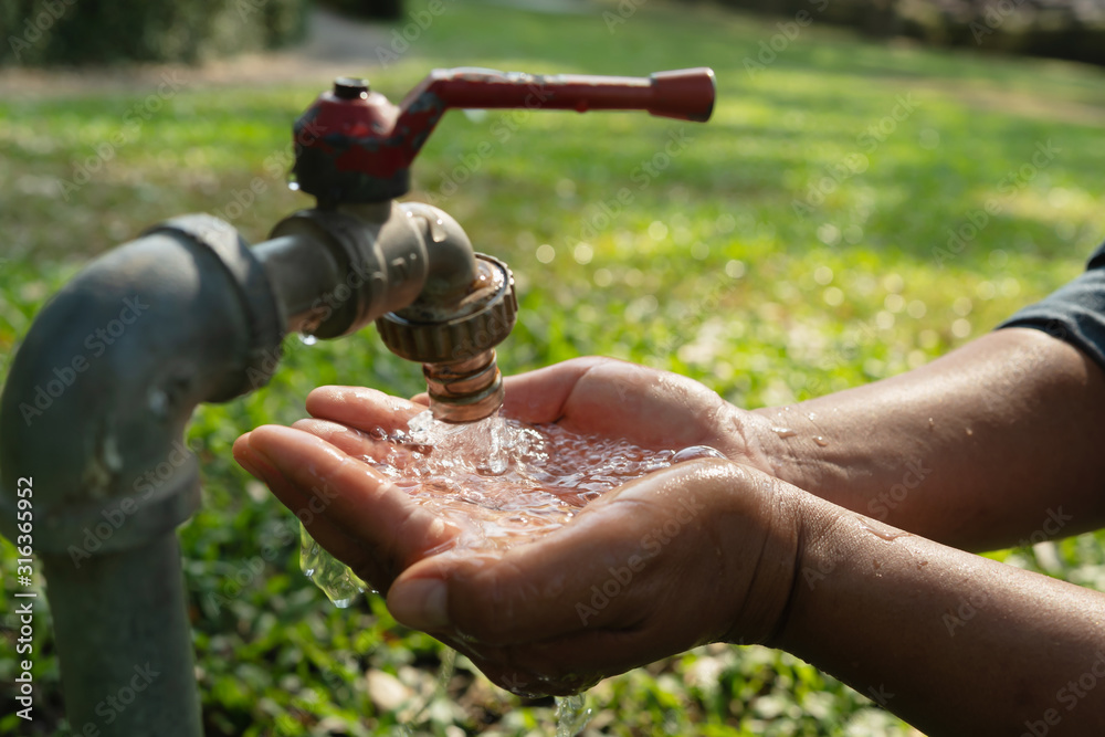 Hand water from the tap to drink. Stock Photo | Adobe Stock