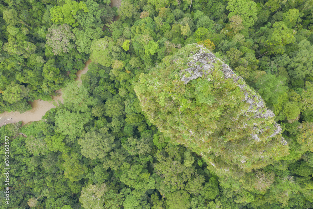 Aerial view of legendary Batu Punggul Pinnacle located at the middle of ...
