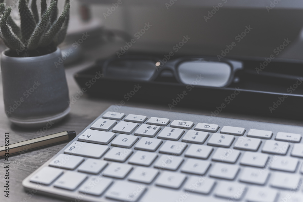 Modern office desk with computer keyboard and office objects on wooden ...