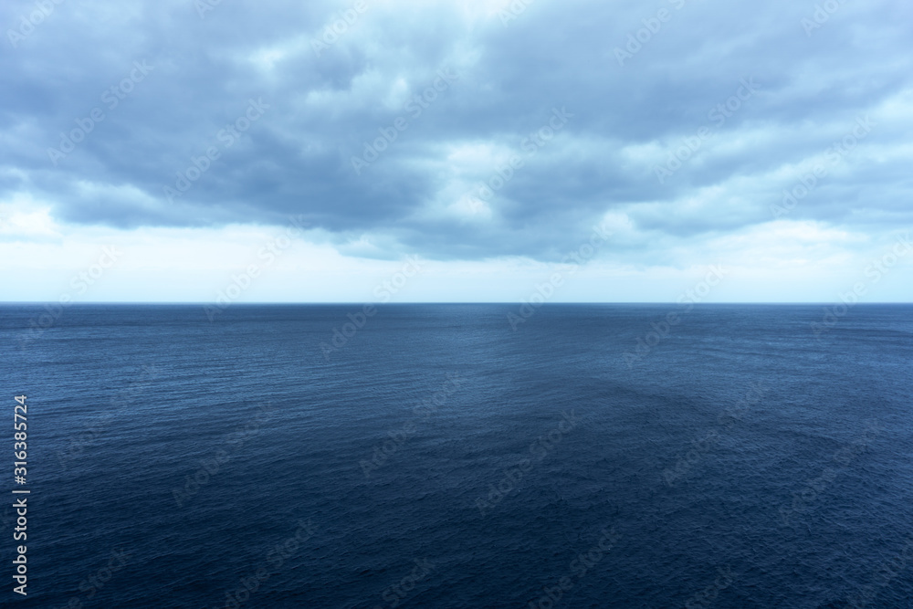 Dark Blue Calm Sea beneath Scenic Clouds Stock Photo | Adobe Stock