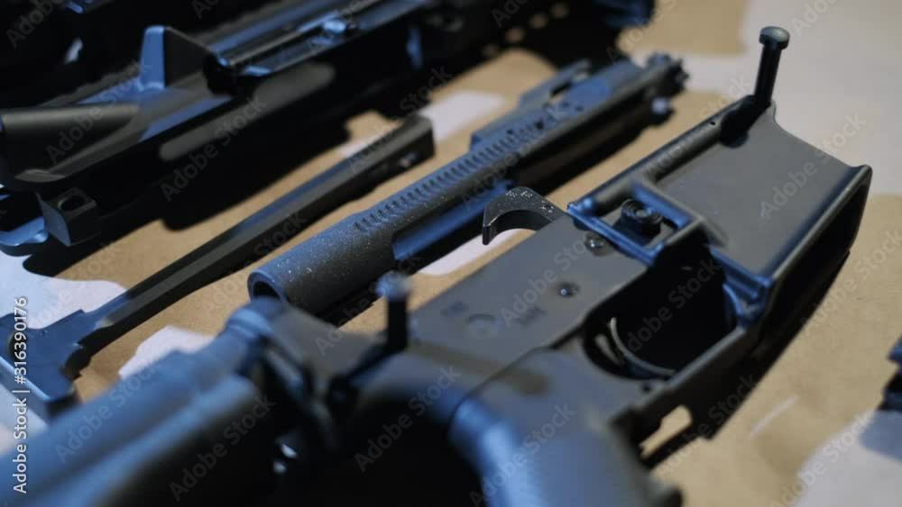 Stockvideon Slide across a disassembled ar15 assault rifle showing the ...