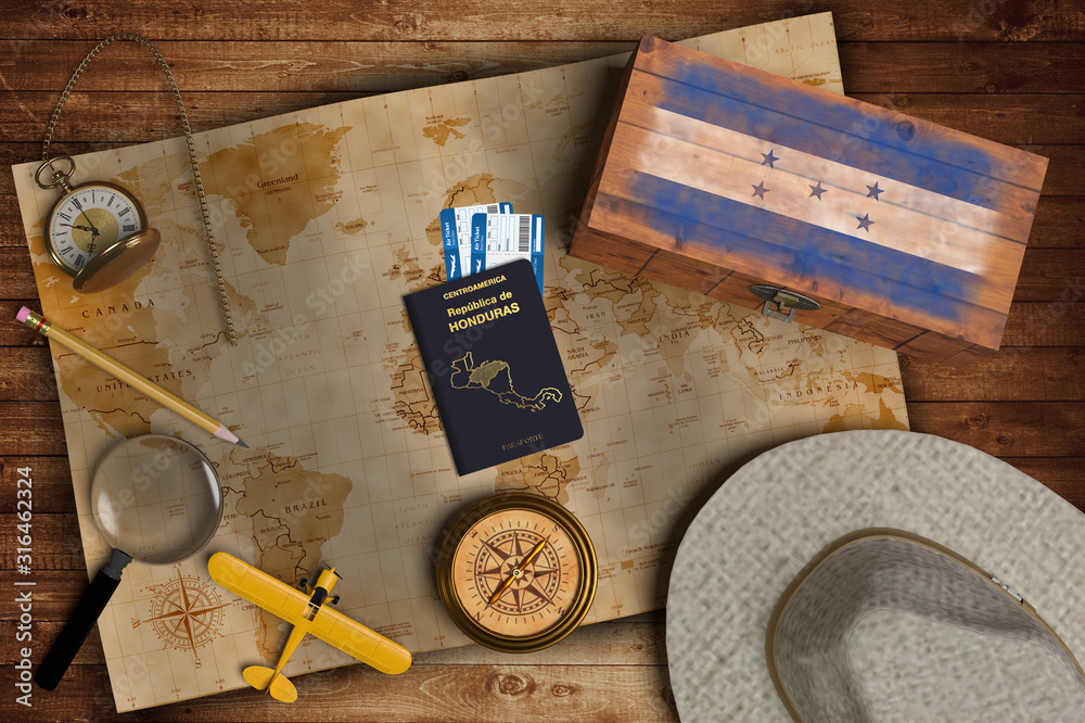 Top view of traveling gadgets, vintage map, magnify glass, hat and ...