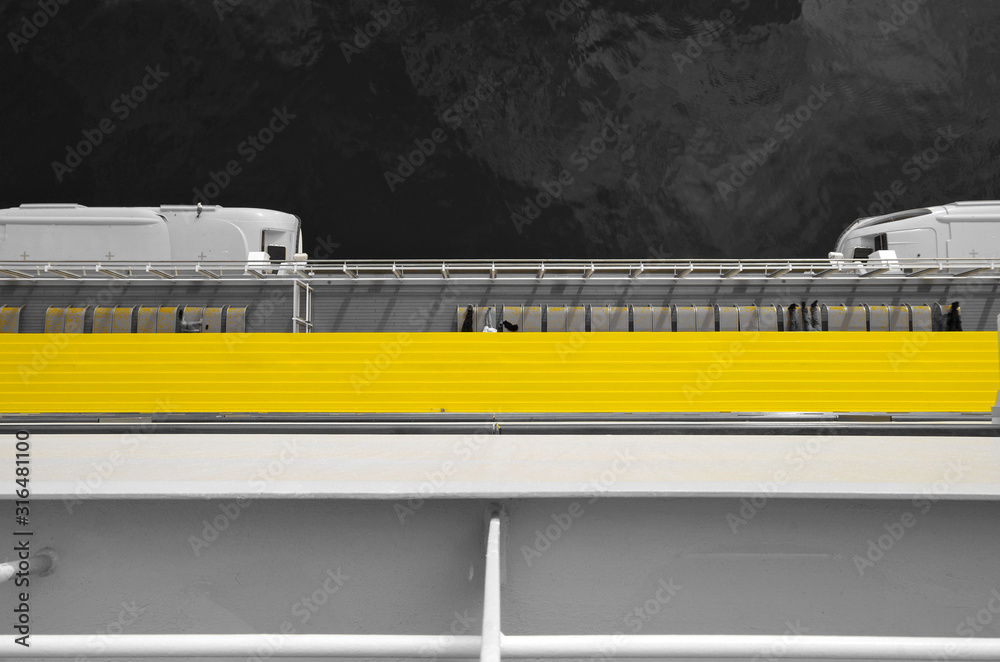 Relaxing on outdoor promenade with sun umbrellas and deck chairs with ...