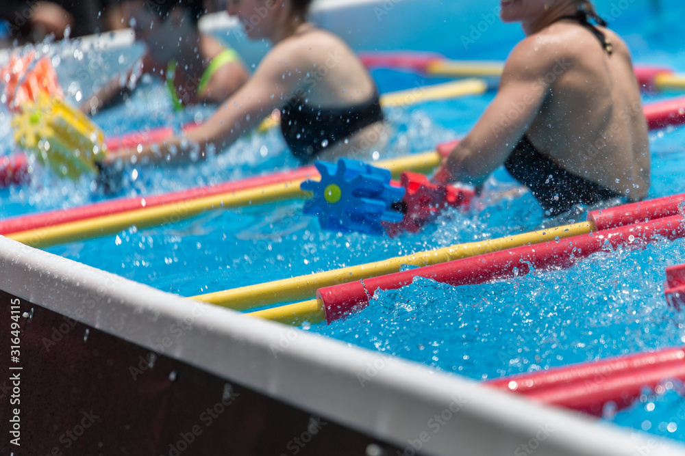 Girls Doing Water Aerobics with Floating Pool Dumbbells Outdoor in a ...