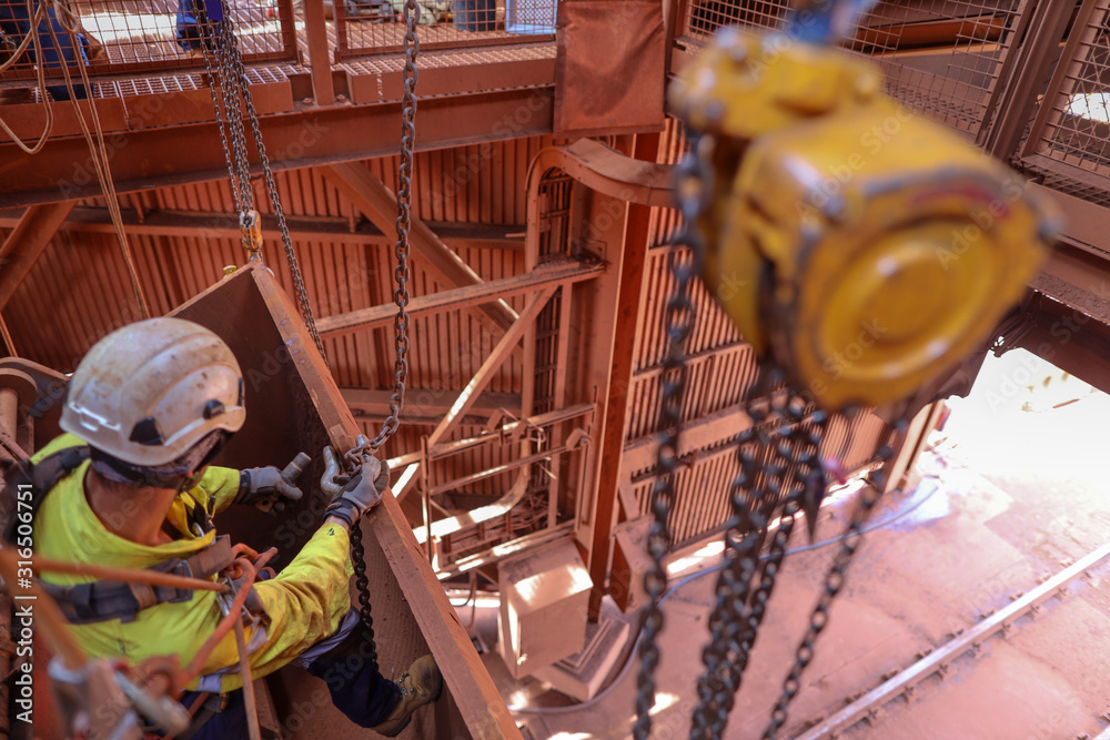 Rigger high risk worker wearing harness safety helmet heavy duty glove ...