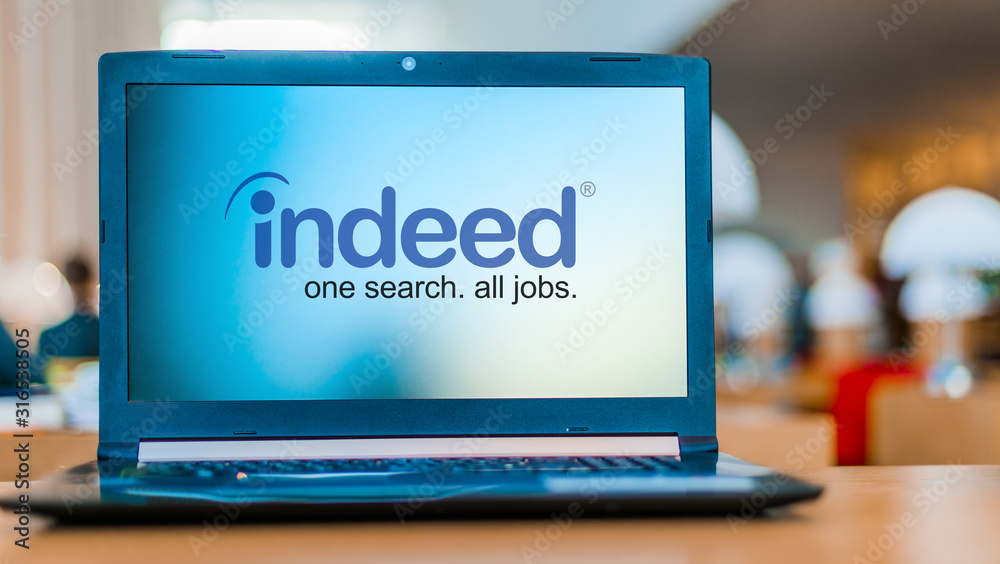Laptop computer displaying logo of Indeed Stock Photo | Adobe Stock