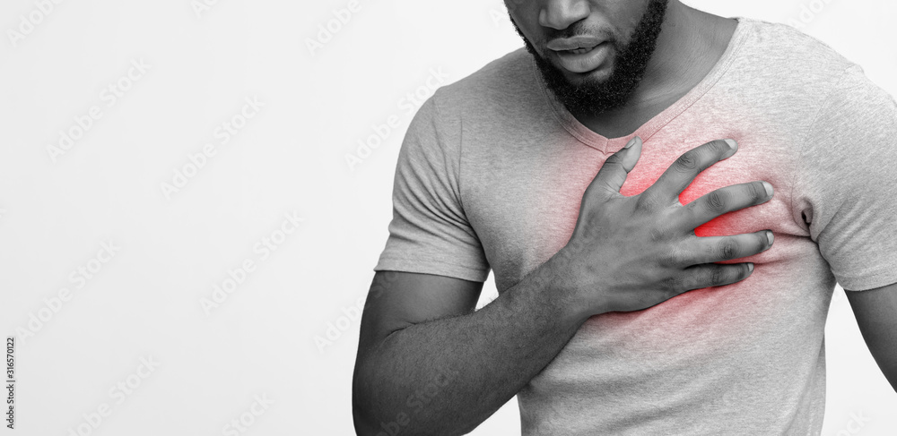 Cropped of afro man touching his left side chest Stock Photo | Adobe Stock
