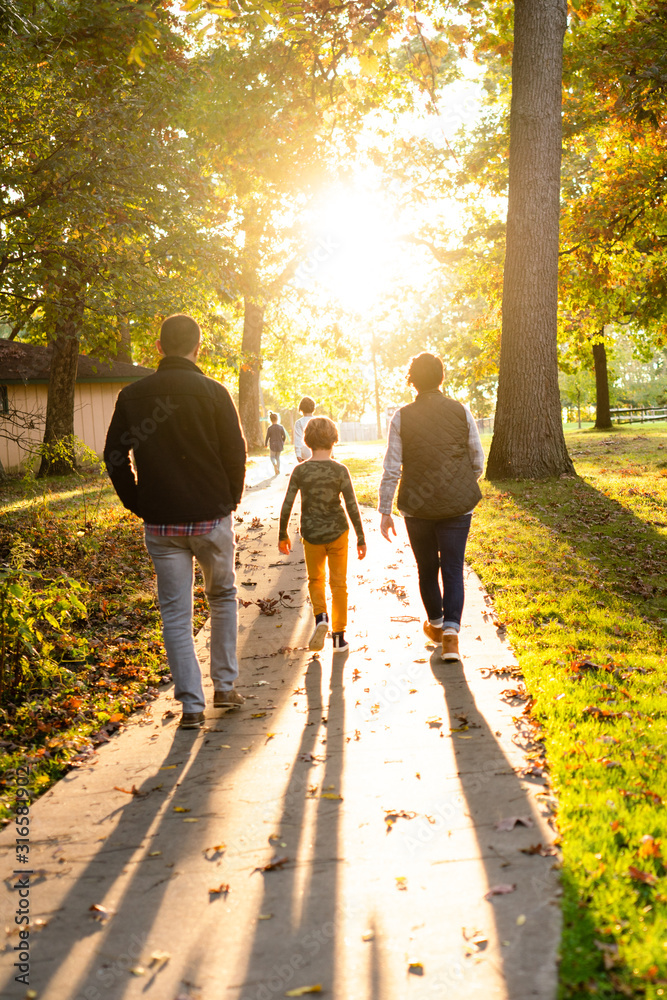 Family walking on a sidewalk at a park in autumn Stock Photo | Adobe Stock