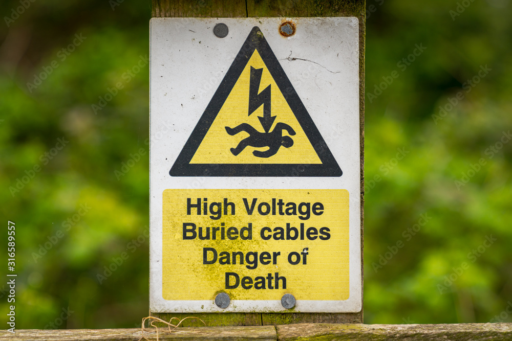 Sign: High Voltage, buried cables, danger of death Stock Photo | Adobe ...