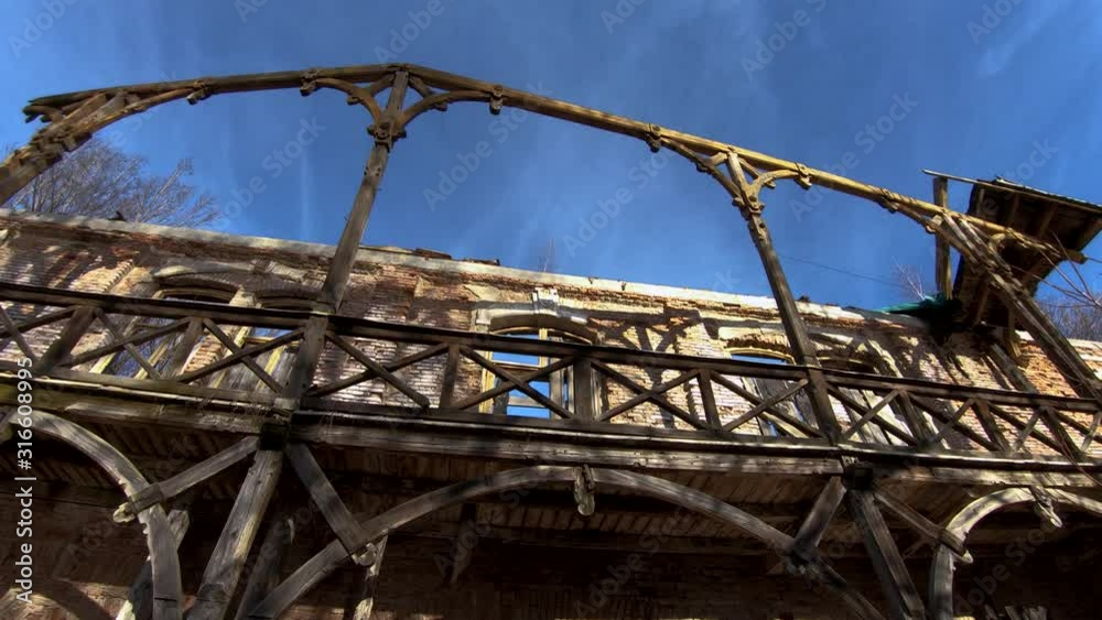 Forward moving tilt up close up old wooden beams and balcony abandoned ...