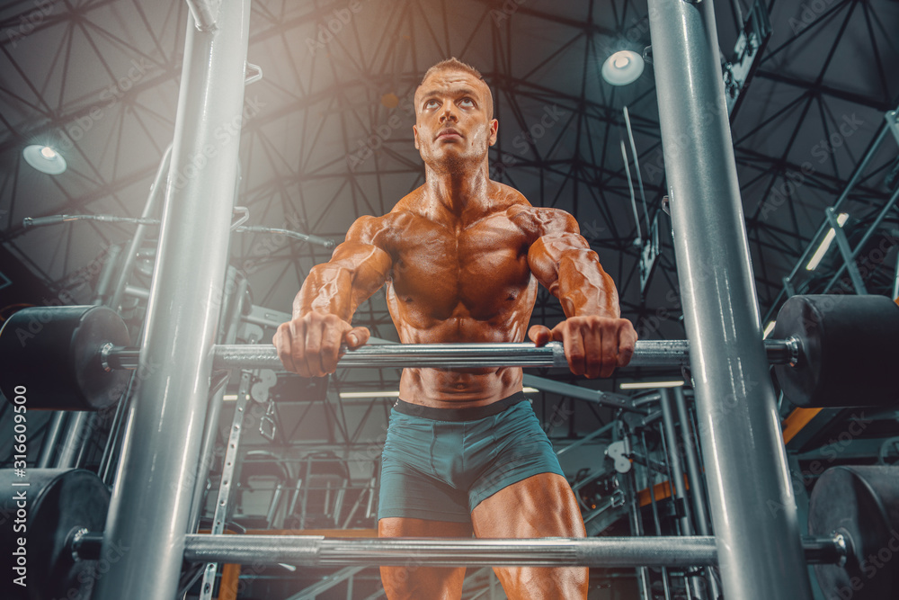 Strong, Muscular, Handsome Men Flexing Muscles in the Gym. Bodybuilder ...