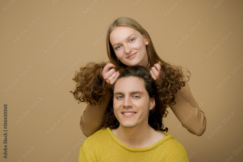 Handsome man with long wavy hair and his cute girlfriend. Beautiful ...