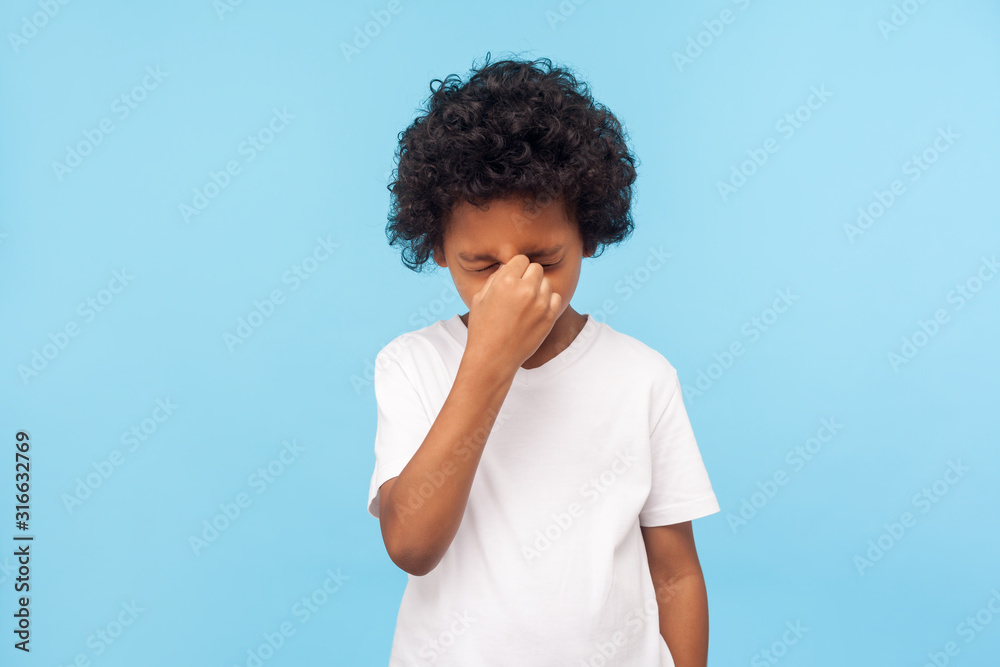 Dramatic unhappy child emotions. Profile of sad little boy with curly ...