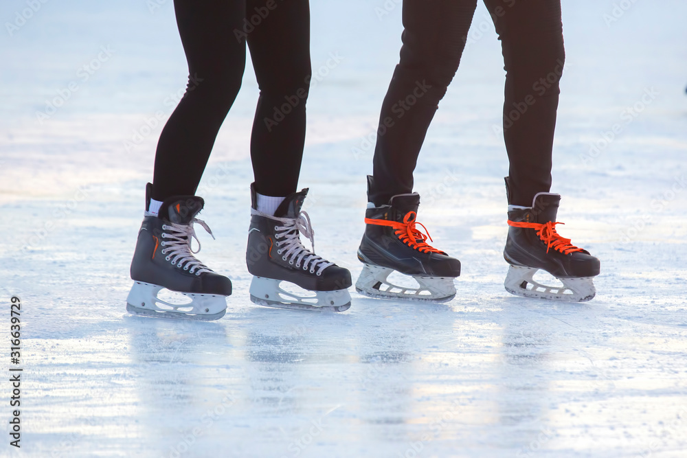 feet on the skates of a person rolling on the ice rink. Hobbies and ...